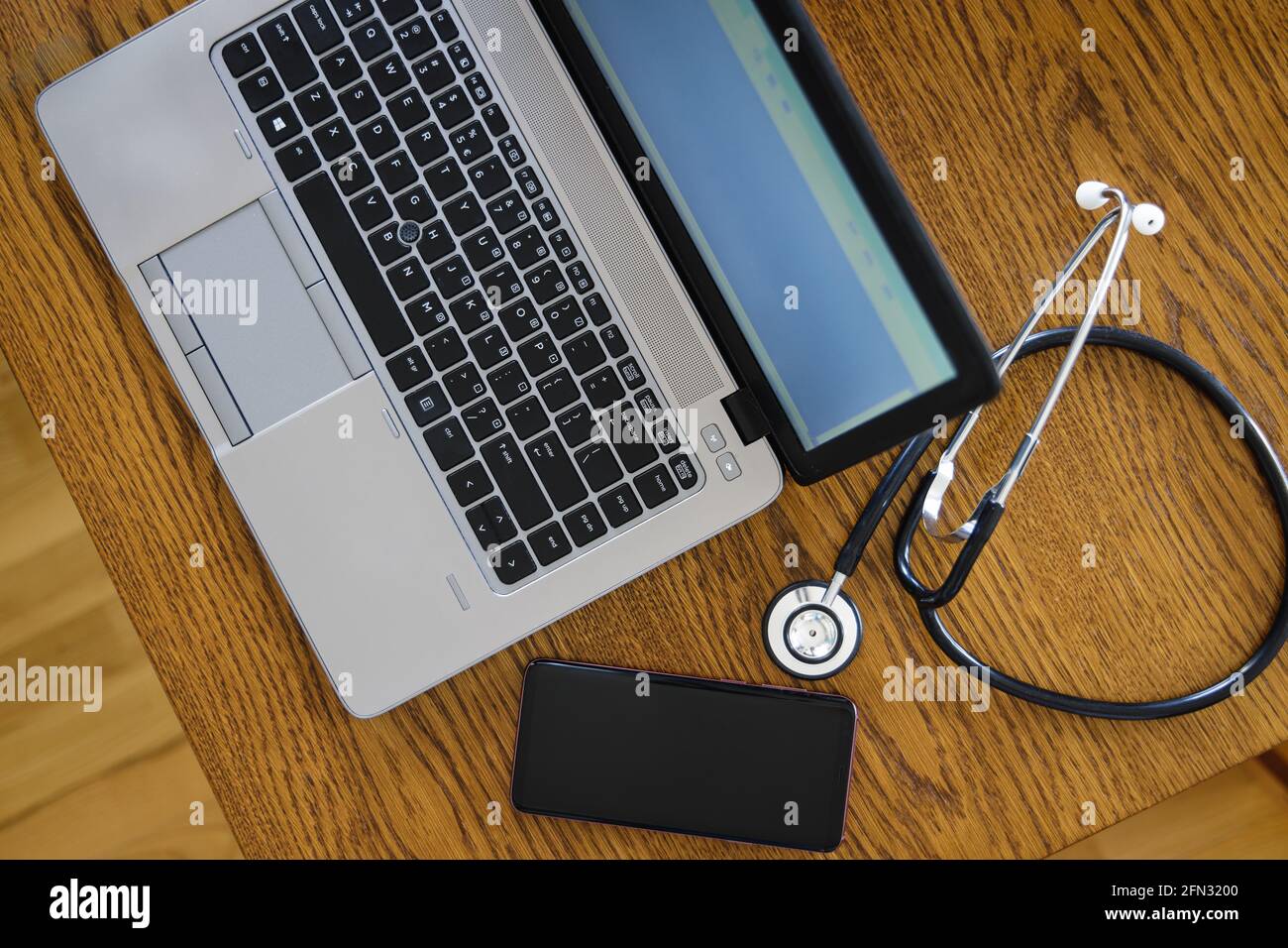 Telemedicine, remote advice and diagnose, laptop, mobile phone and ...