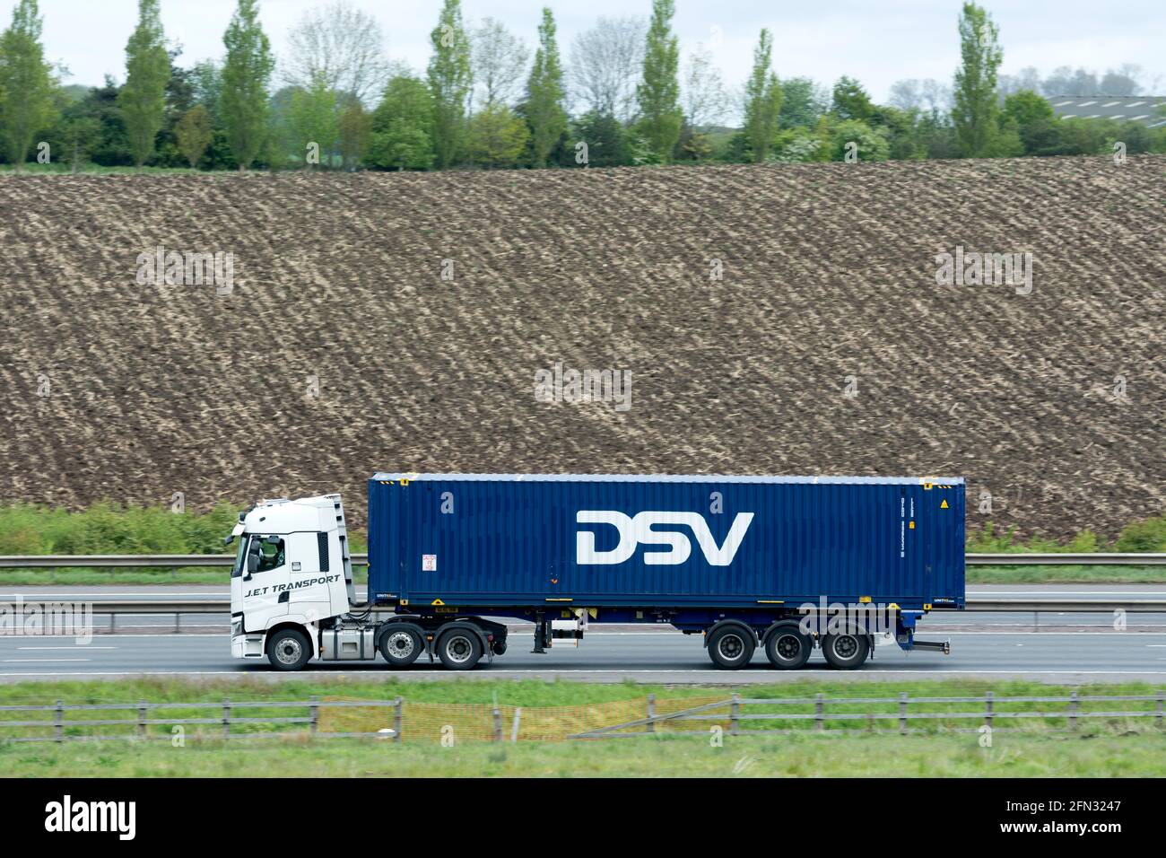 A DSV shipping container transported on the M40 motorway, Warwickshire ...