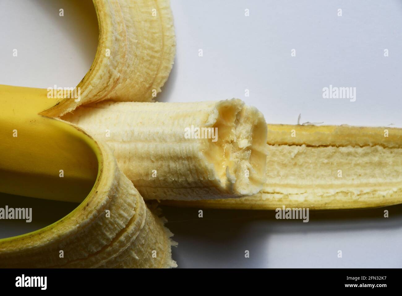 Half eaten Banana ,partially pealed, ripe yellow,healthy nutricious ...