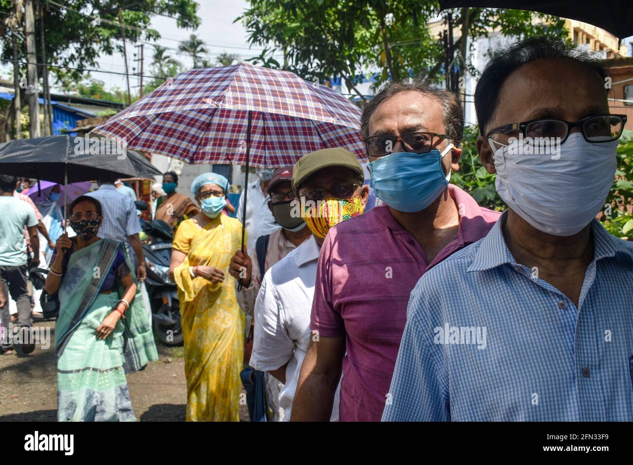 People are waiting outside a West Bengal state Health Centre to take ...