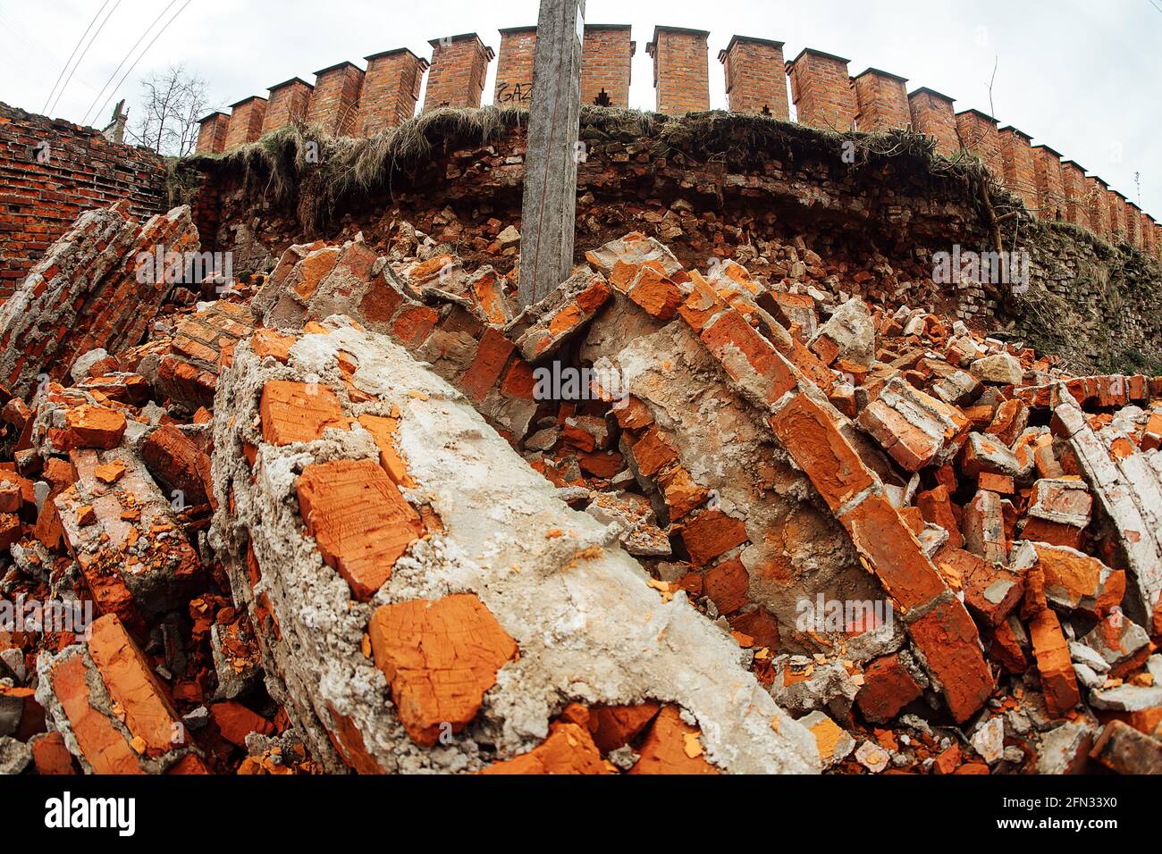 a brick wall destroyed by an explosion. the war destroys historical ...