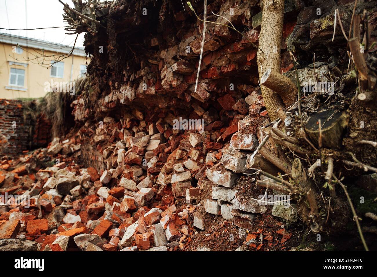a brick wall destroyed by an explosion. the war destroys historical ...