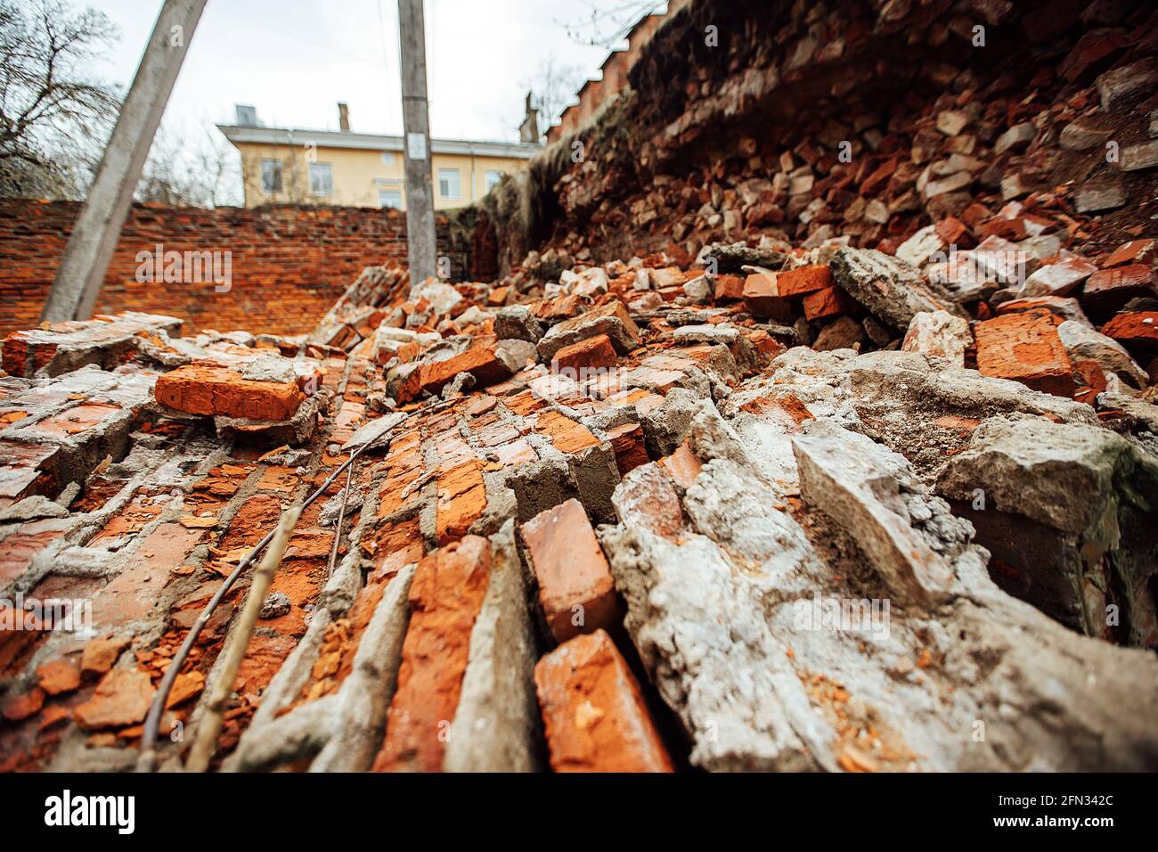 a brick wall destroyed by an explosion. the war destroys historical ...