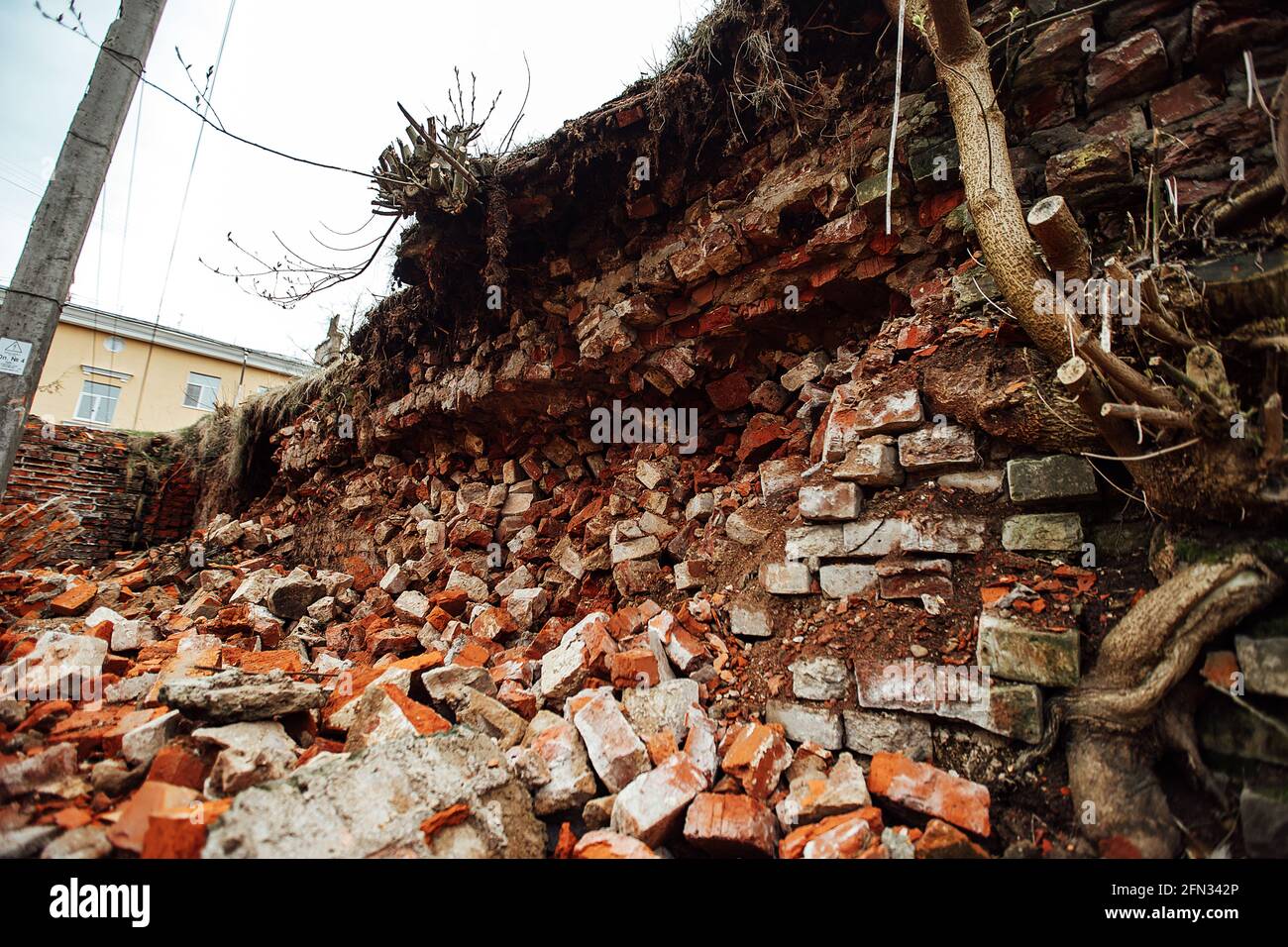 a brick wall destroyed by an explosion. the war destroys historical ...