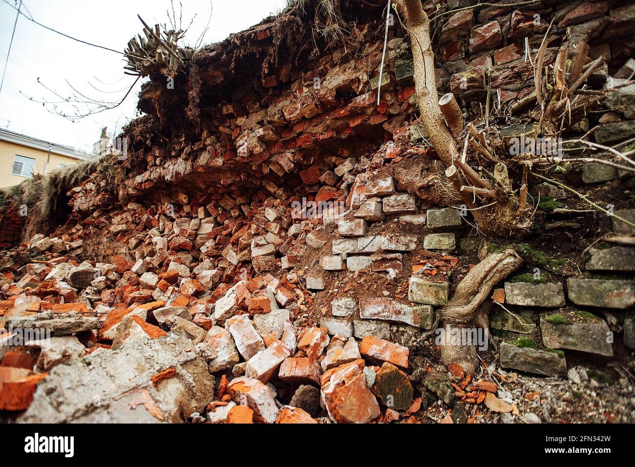 a brick wall destroyed by an explosion. the war destroys historical ...