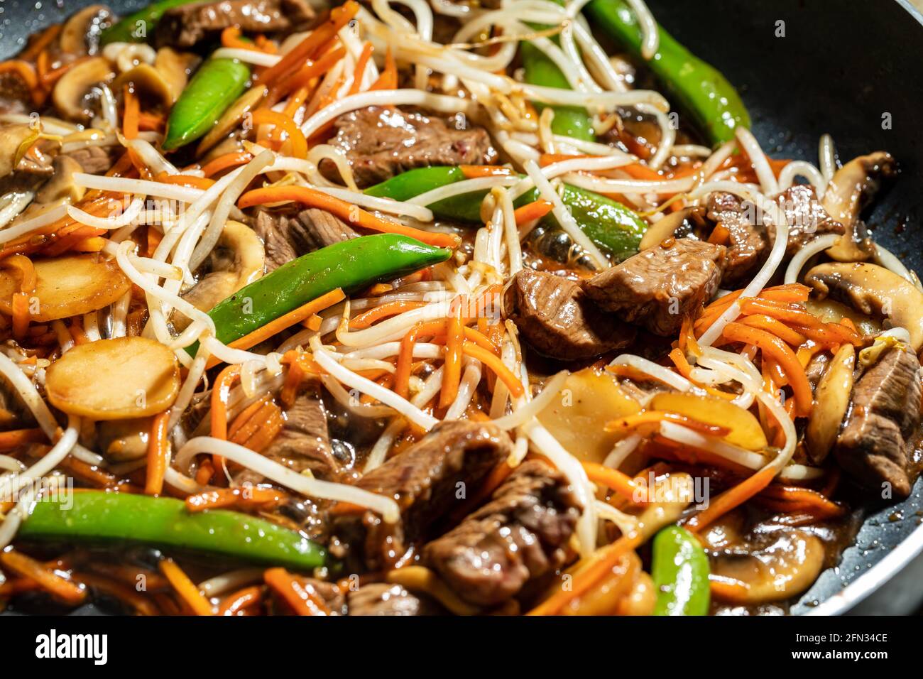 Closeup of Stir-fry in a skillet being Cooking to perfection Stock ...