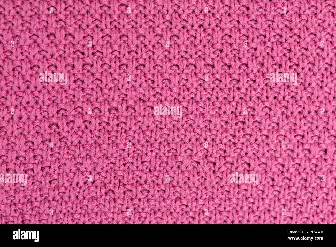 Pink knitted fabric pearl woolen background. The structure of the ...