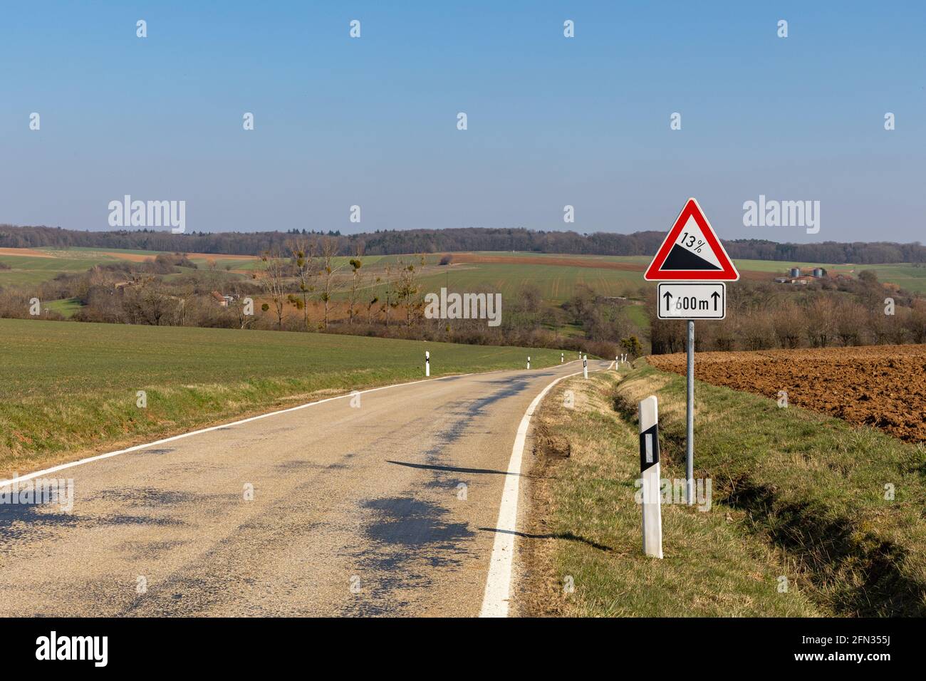With road and road sign inclined road Stock Photo - Alamy