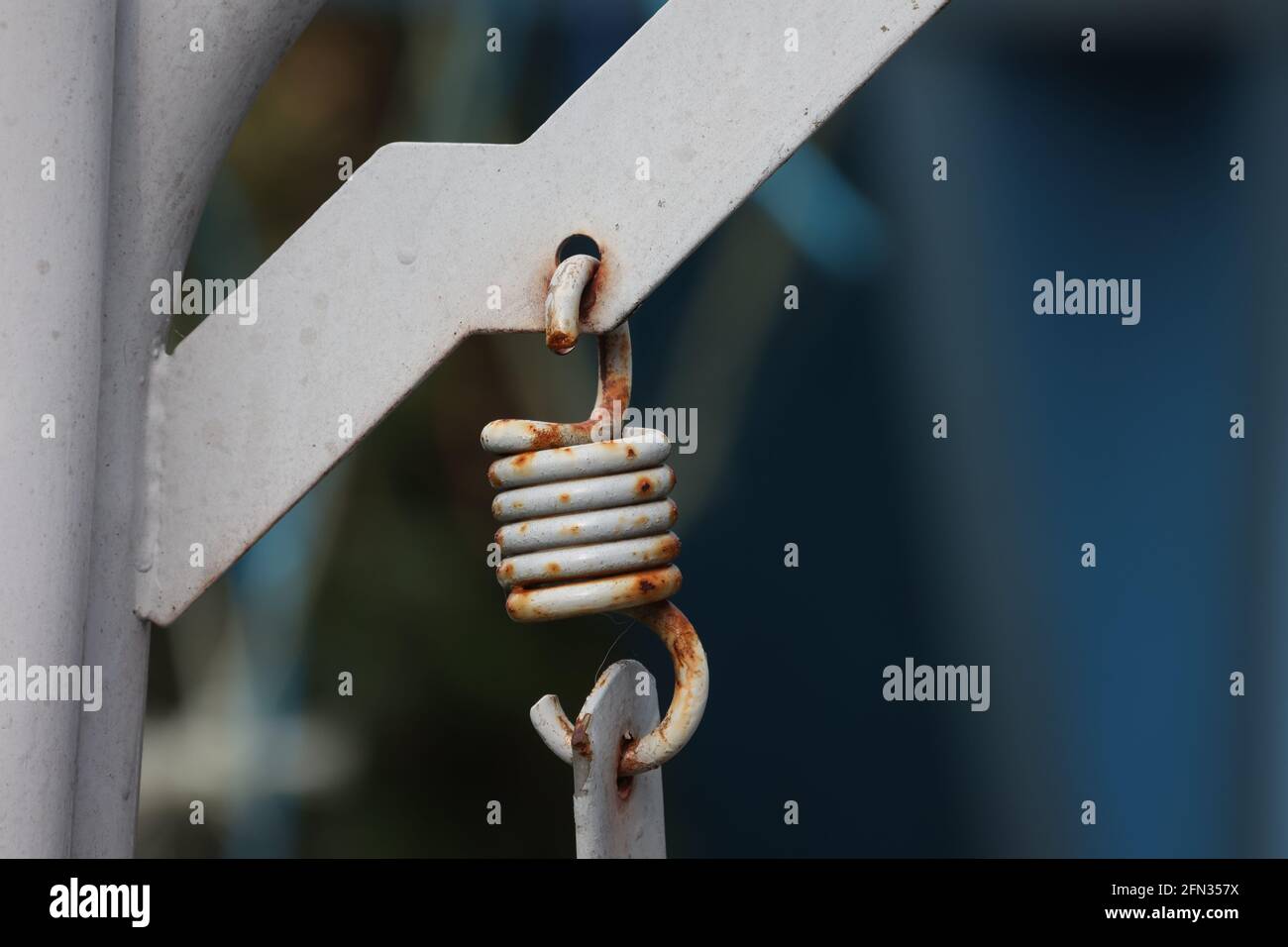Rusty metal spring on a rocking chair Stock Photo - Alamy