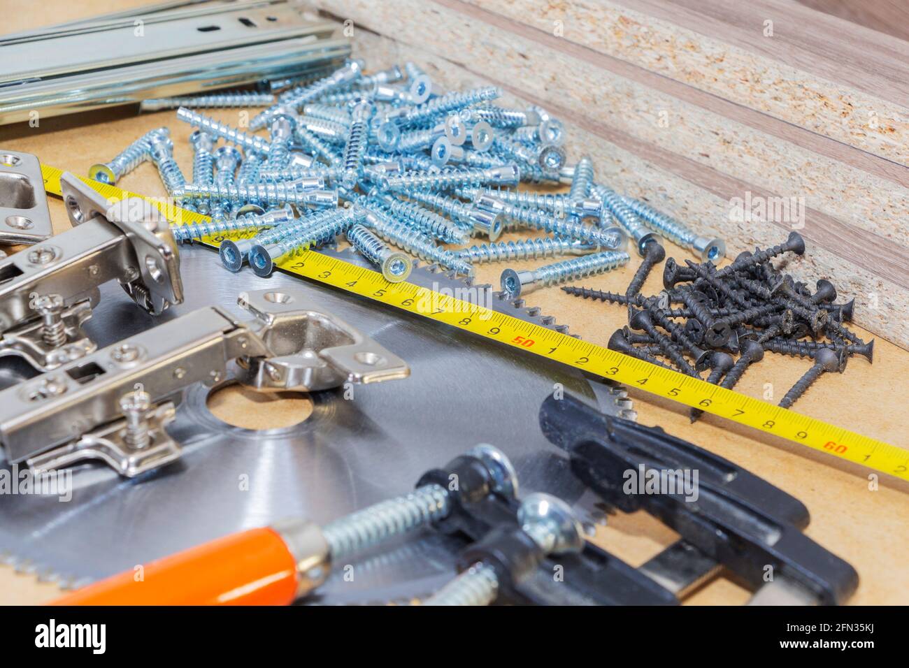 Screws, confirmations for furniture, tape measure, clamp, lie on the ...