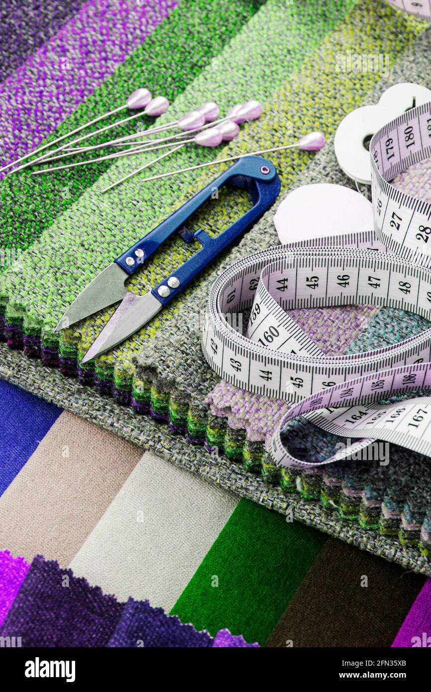 Pieces of cloth with scissors, needle and thread. Tailoring ...