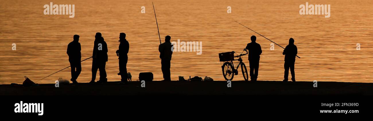 human silhouettes in front of the sea background. Front view people ...
