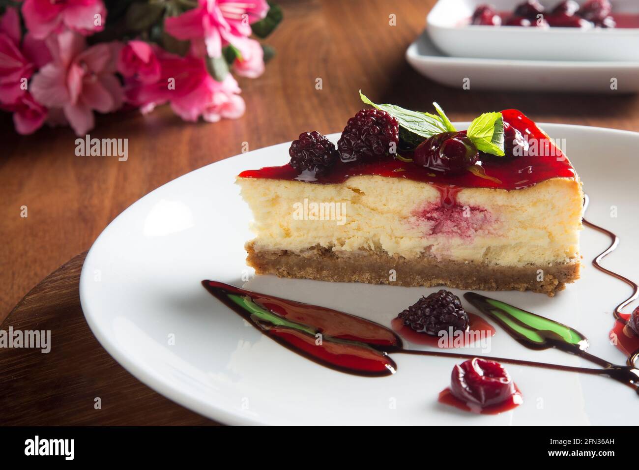 Cheesecake in a white plate. Front view Stock Photo - Alamy