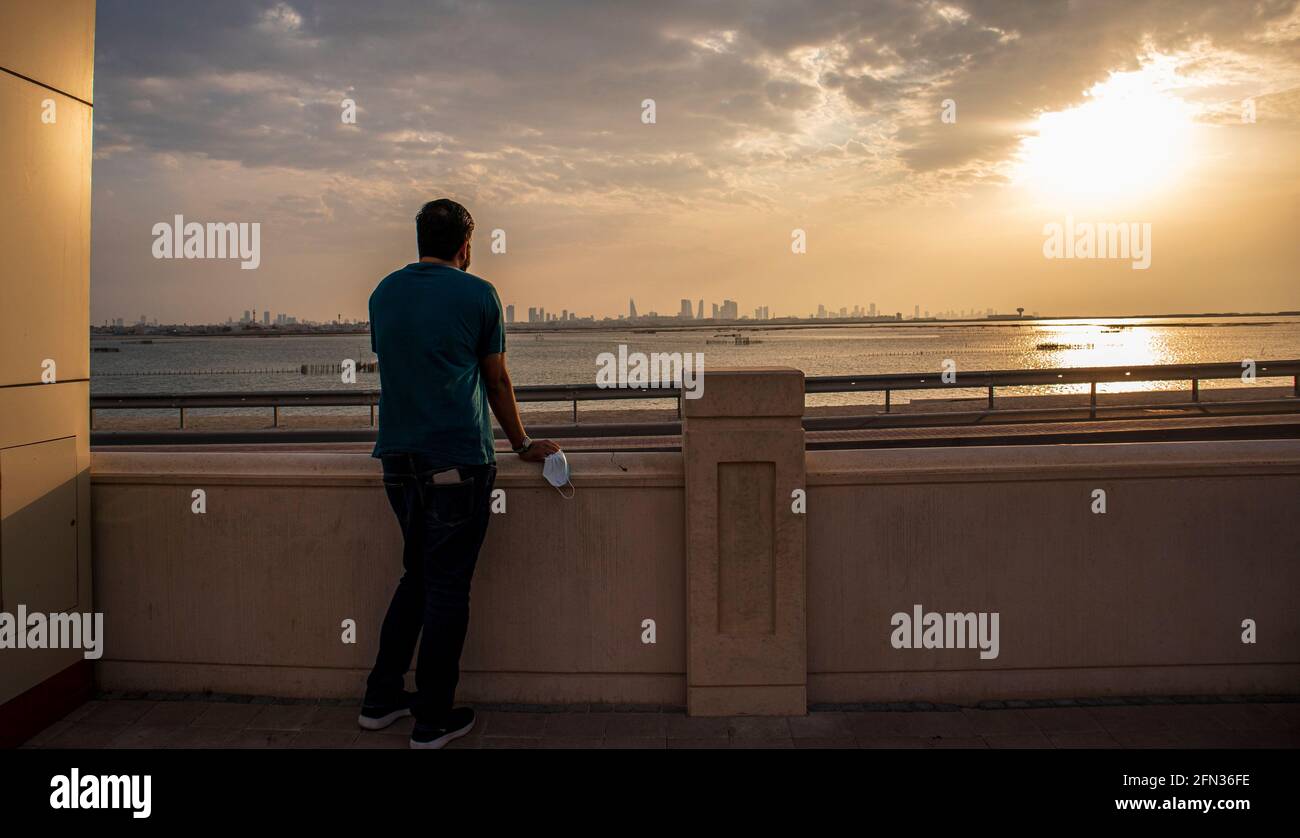 Man alone on the beach and thinking Stock Photo - Alamy