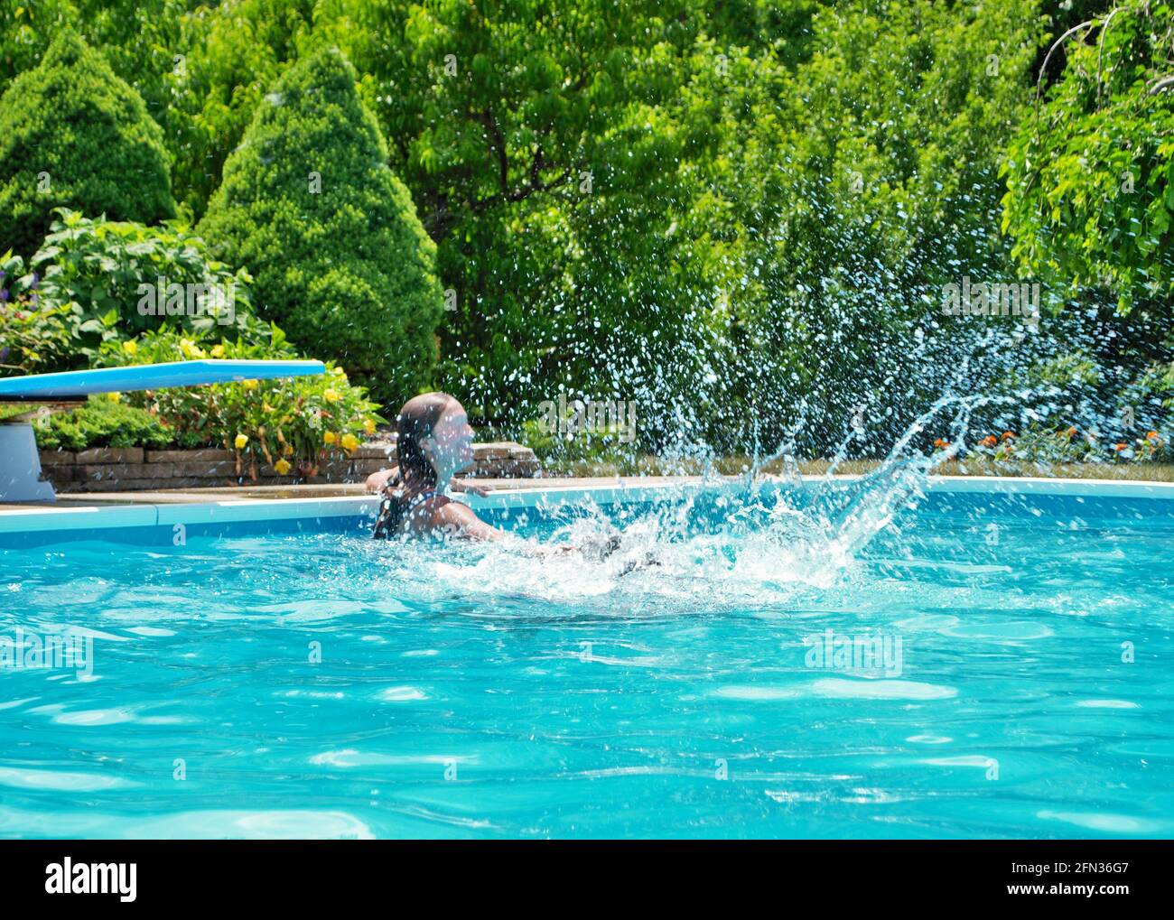 Big splash after someone jumped off the diving board Stock Photo - Alamy