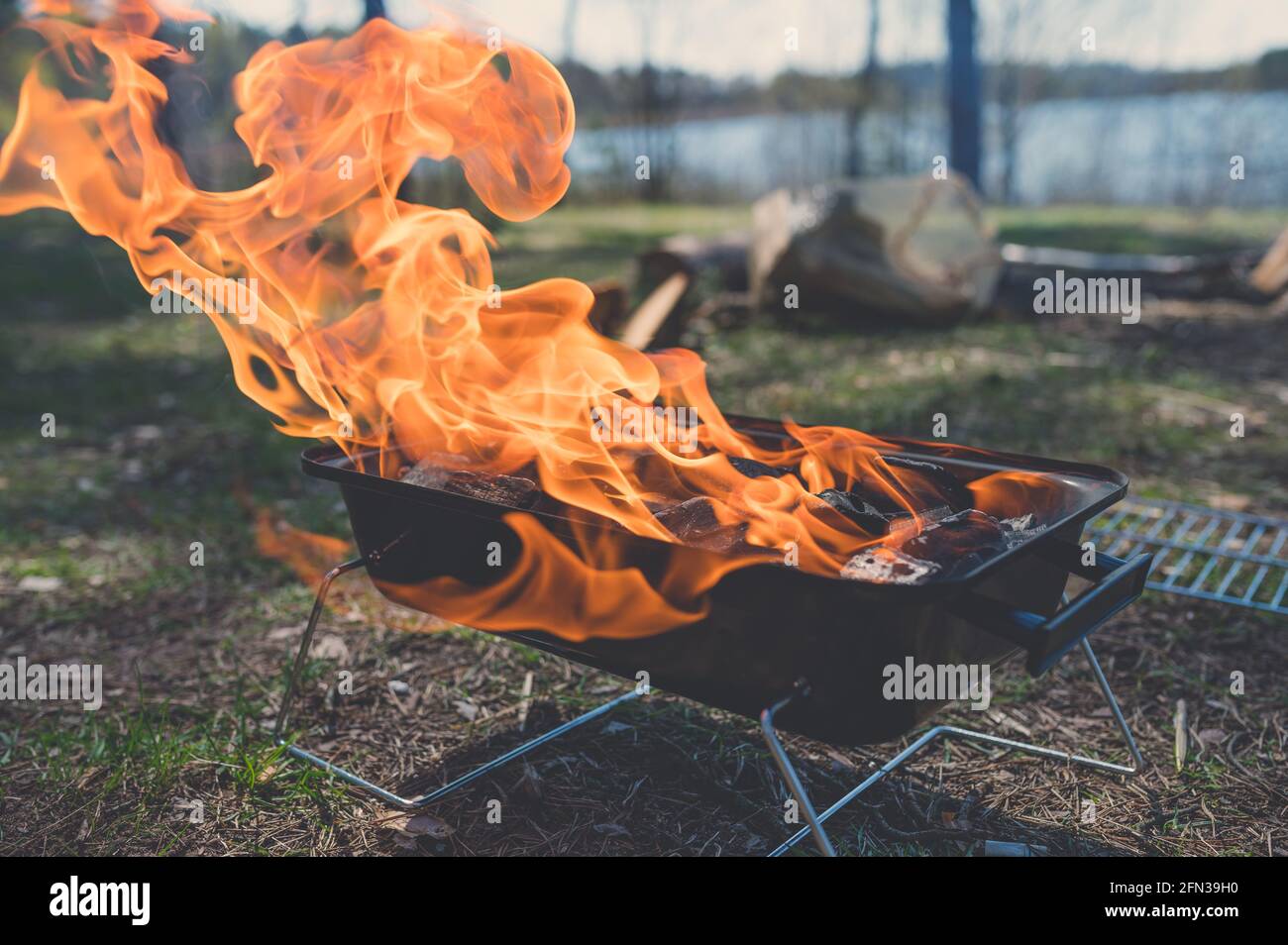 Fire on grill outdoors. Concept of outdoor cooking. Vintage film look ...