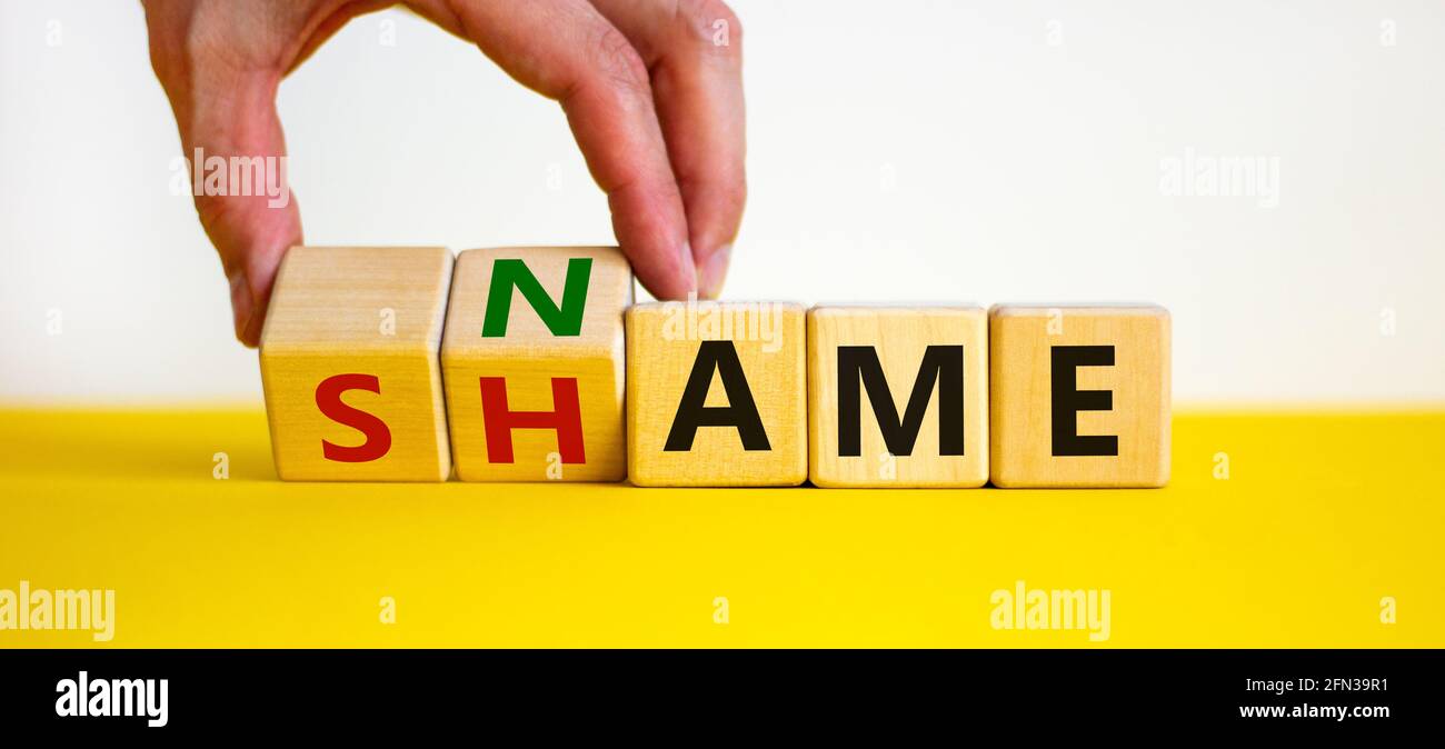 Name or shame symbol. Businessman turns wooden cubes and changes the ...