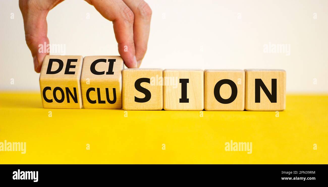 Decision or conclusion symbol. Businessman turns wooden cubes and ...