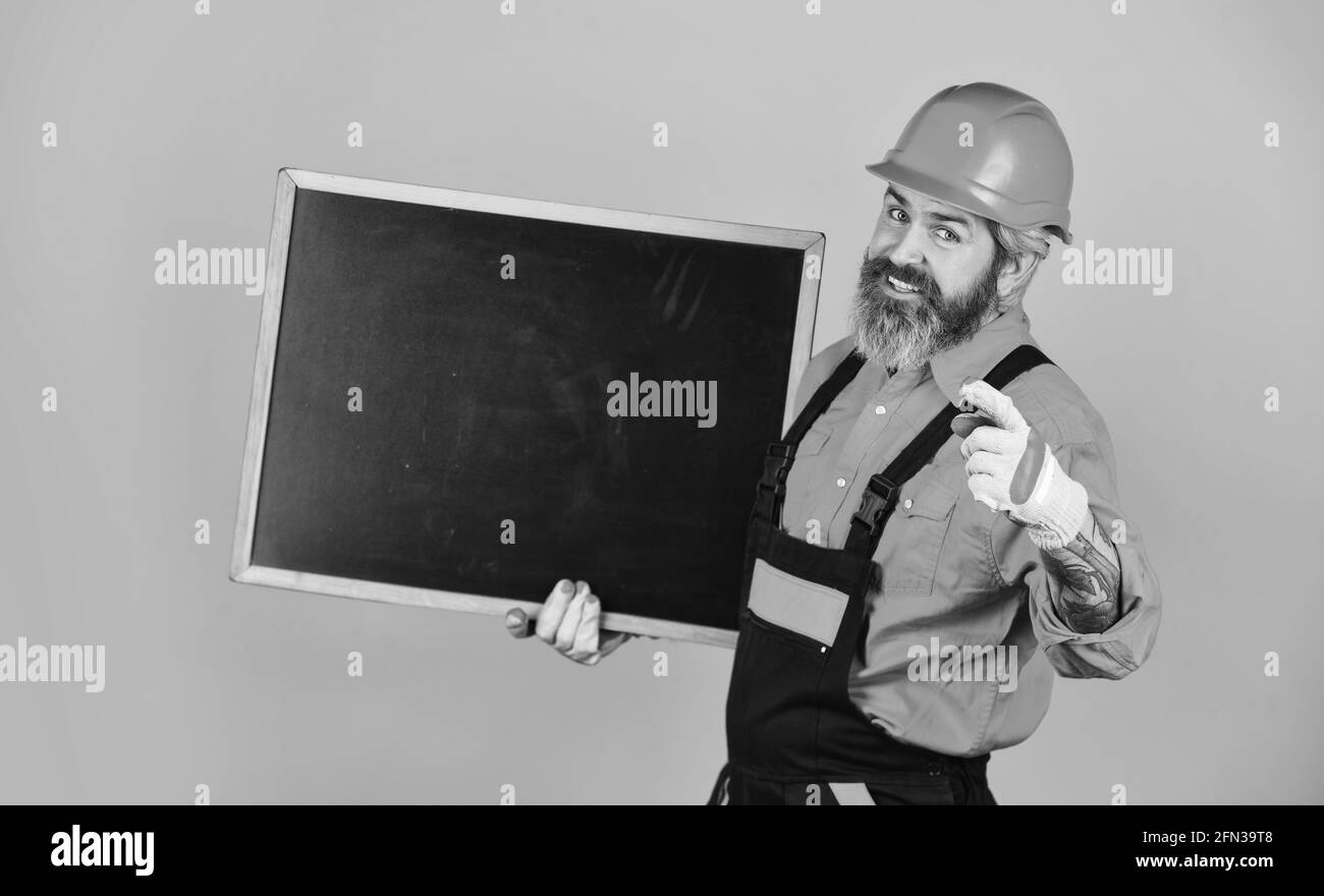 Presentation on blackboard plan for construction. Builder man serious ...