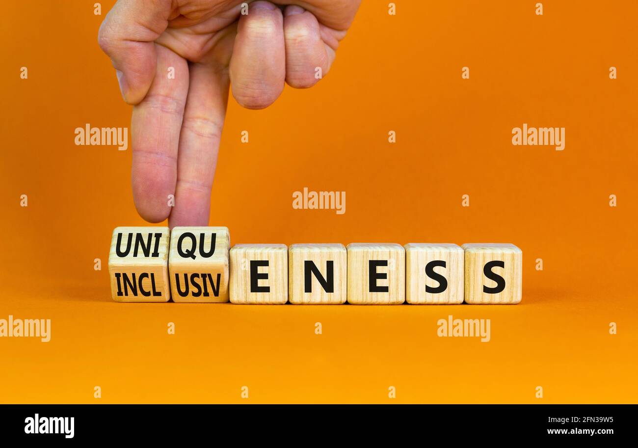 Inclusiveness and uniqueness symbol. Businessman turns wooden cubes ...