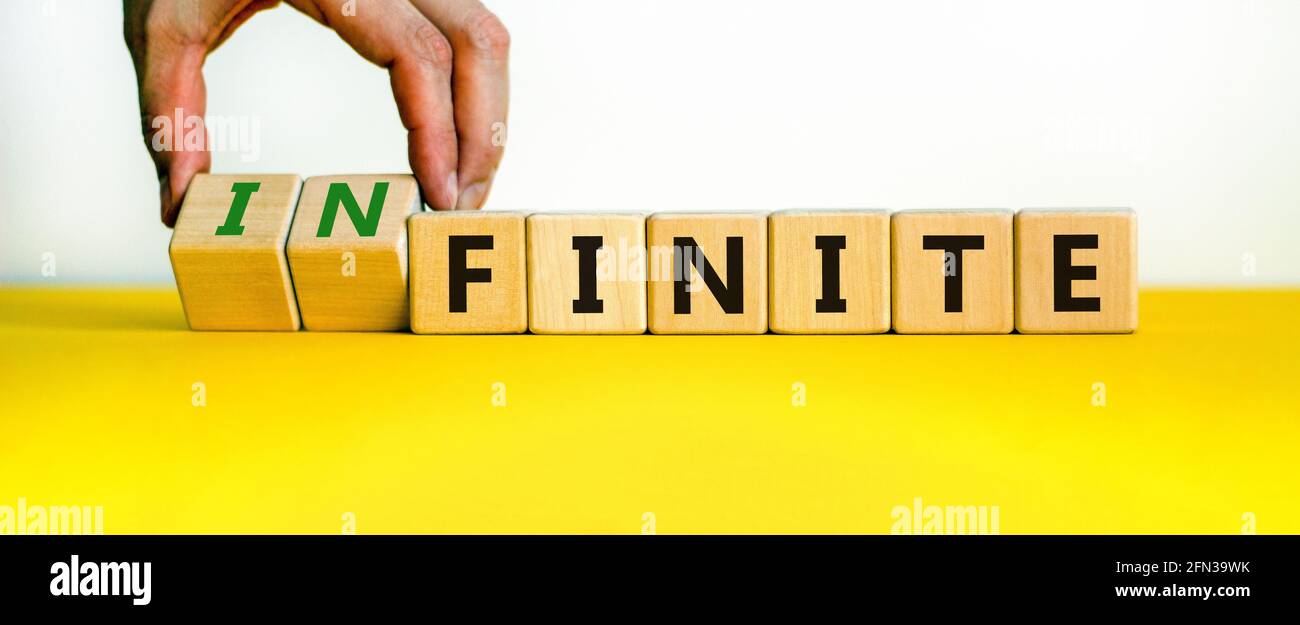 Finite or infinite symbol. Businessman turns wooden cubes and changes ...