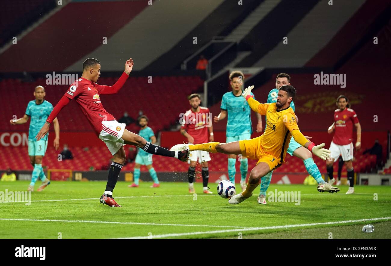Liverpool goalkeeper Alisson saves from Manchester United's Mason ...