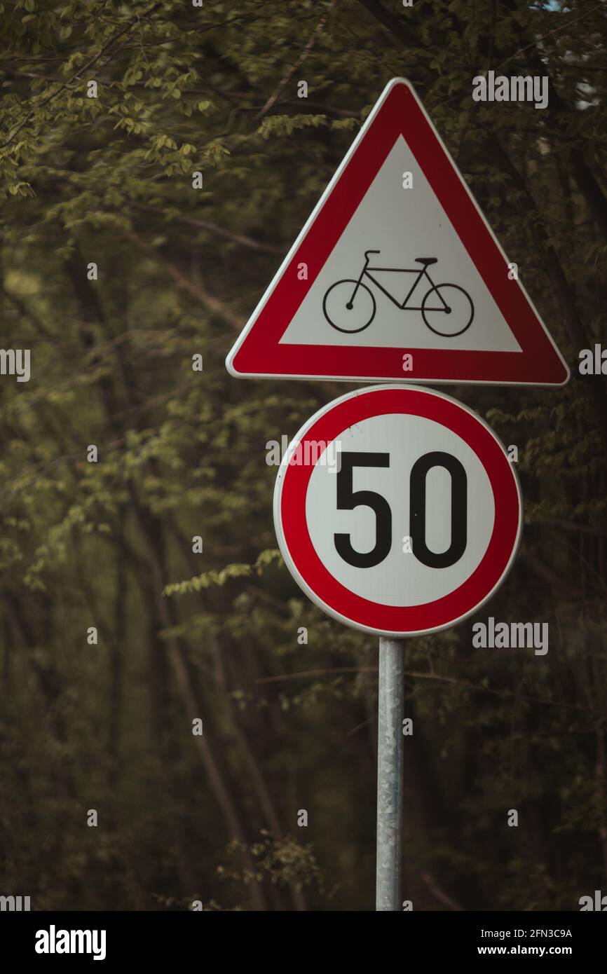Vertical shot of road signs showing the maximum speed limit and the ...