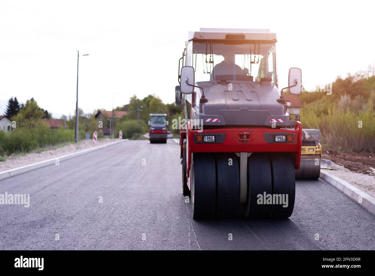 Modern heavy asphalt roller that stack and press hot asphalt. Yellow ...