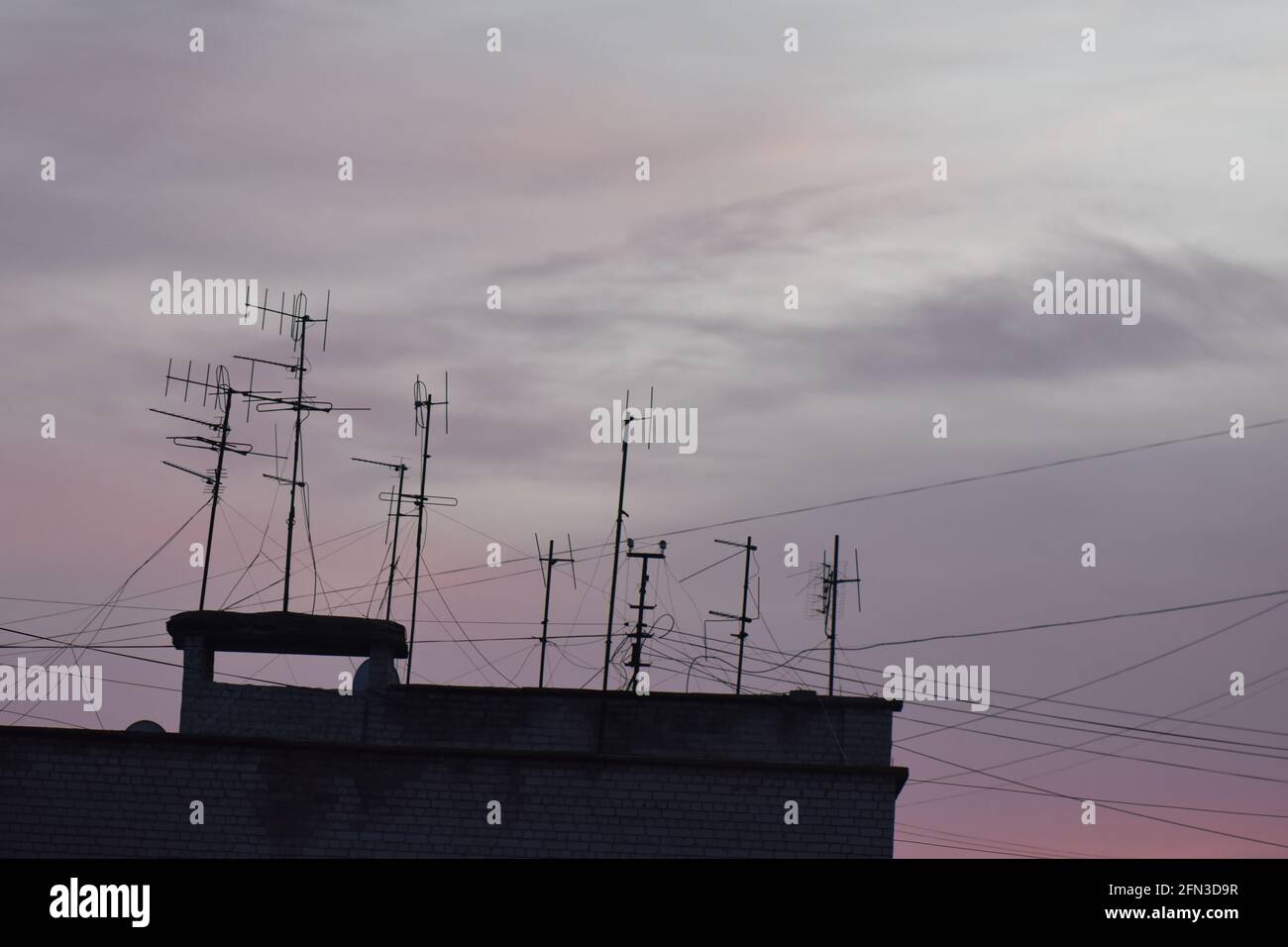 Power lines on the top of the building at sunset Stock Photo - Alamy