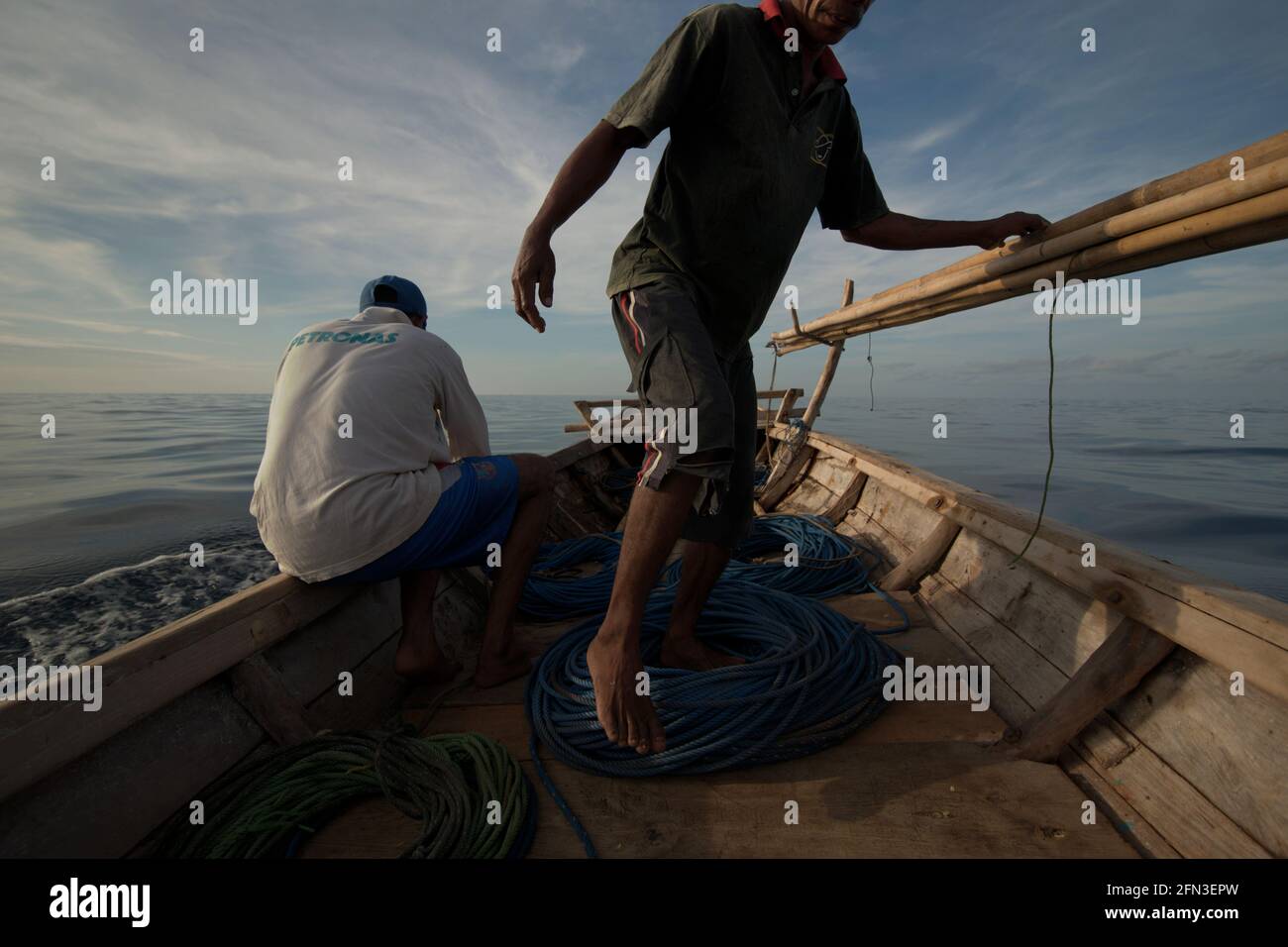 Whale hunters on traditional whaling boat equipped with bamboo harpoons ...