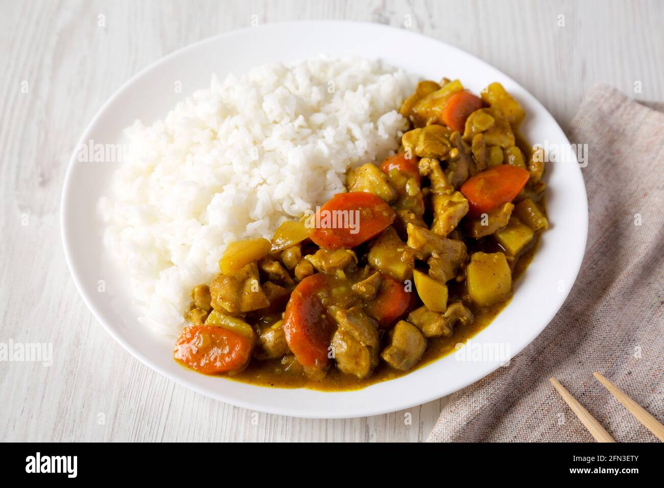 Homemade Japanese Chicken Curry on a white plate on a white wooden ...