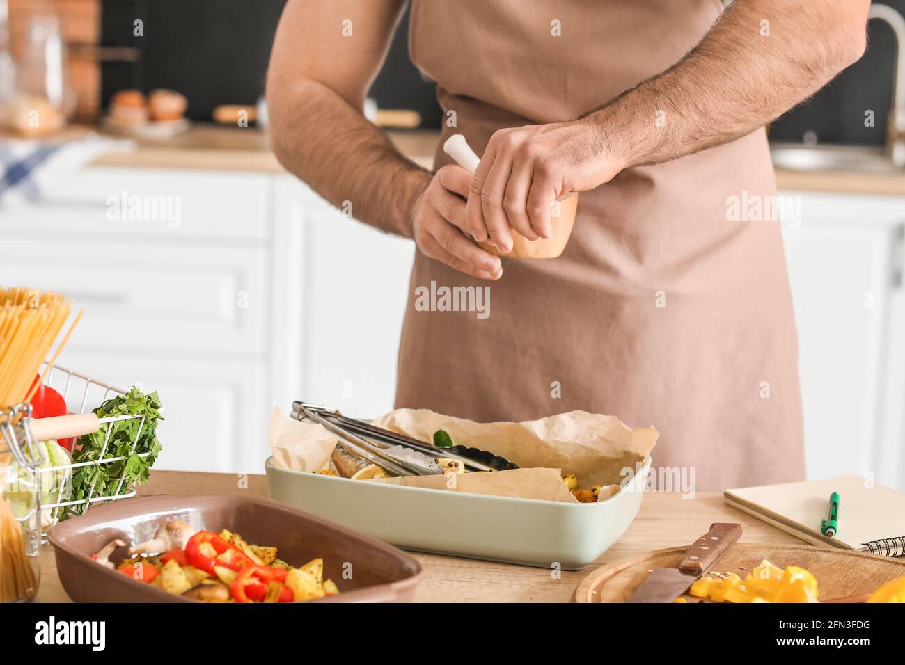 Young man cooking in kitchen Stock Photo - Alamy