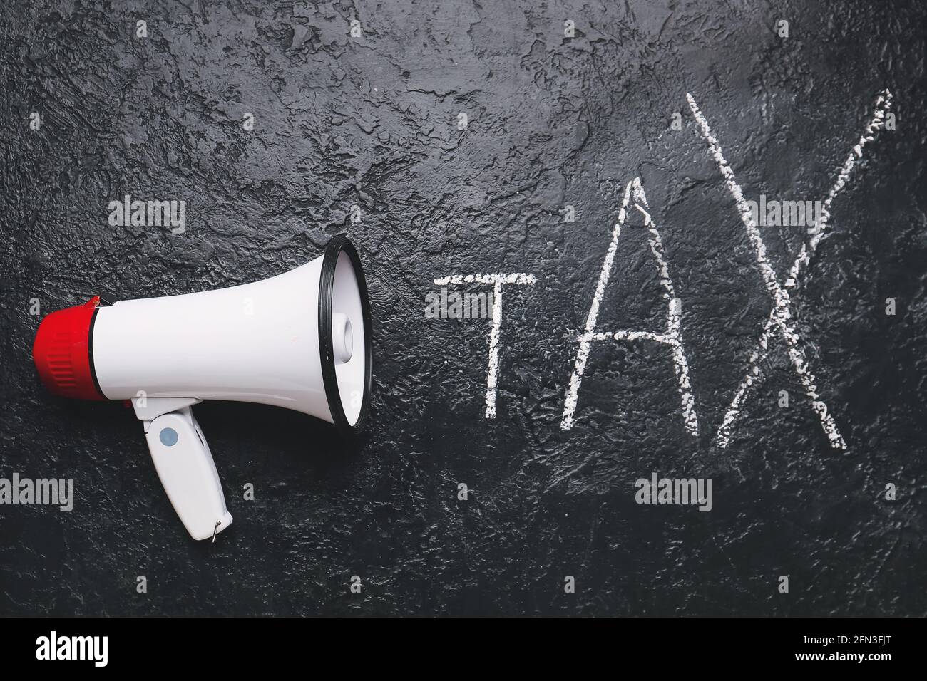 Word TAX and megaphone on dark background Stock Photo - Alamy