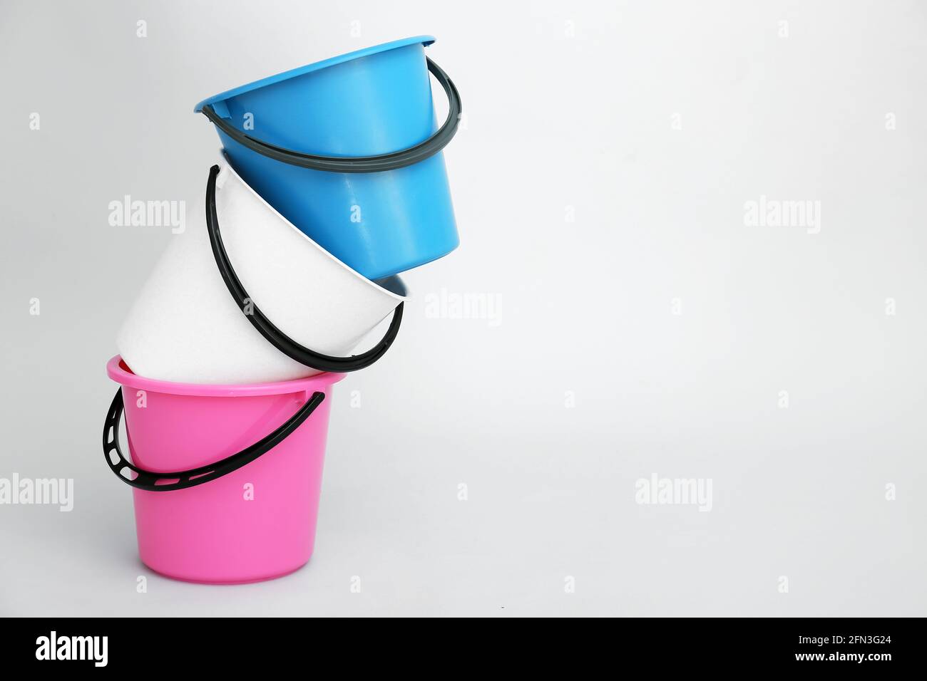 Plastic buckets on light background Stock Photo - Alamy