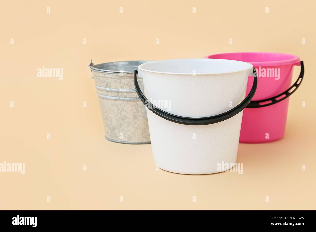 Different buckets on color background Stock Photo - Alamy
