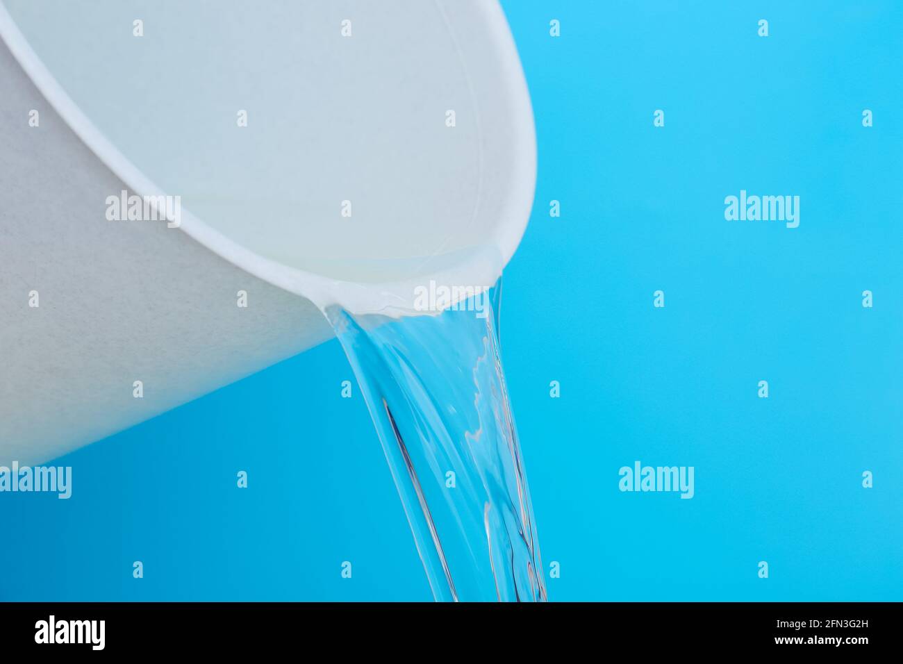 Pouring of water from bucket on color background, closeup Stock Photo ...