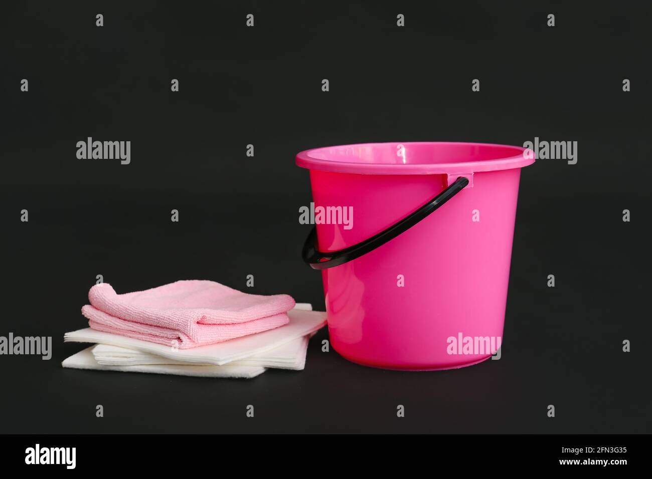 Bucket and rags on dark background Stock Photo - Alamy