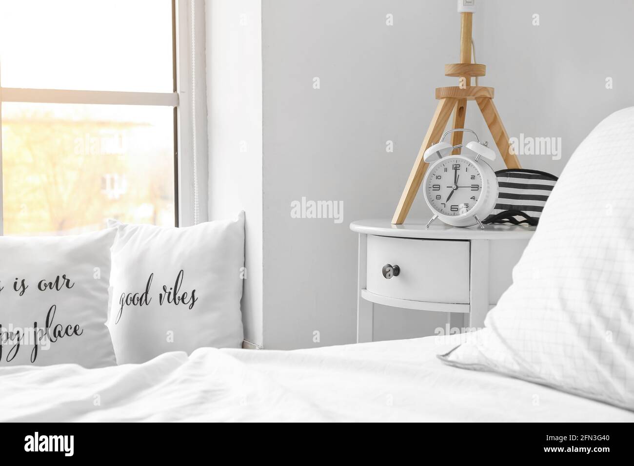 Alarm clock on table in interior of modern room Stock Photo - Alamy