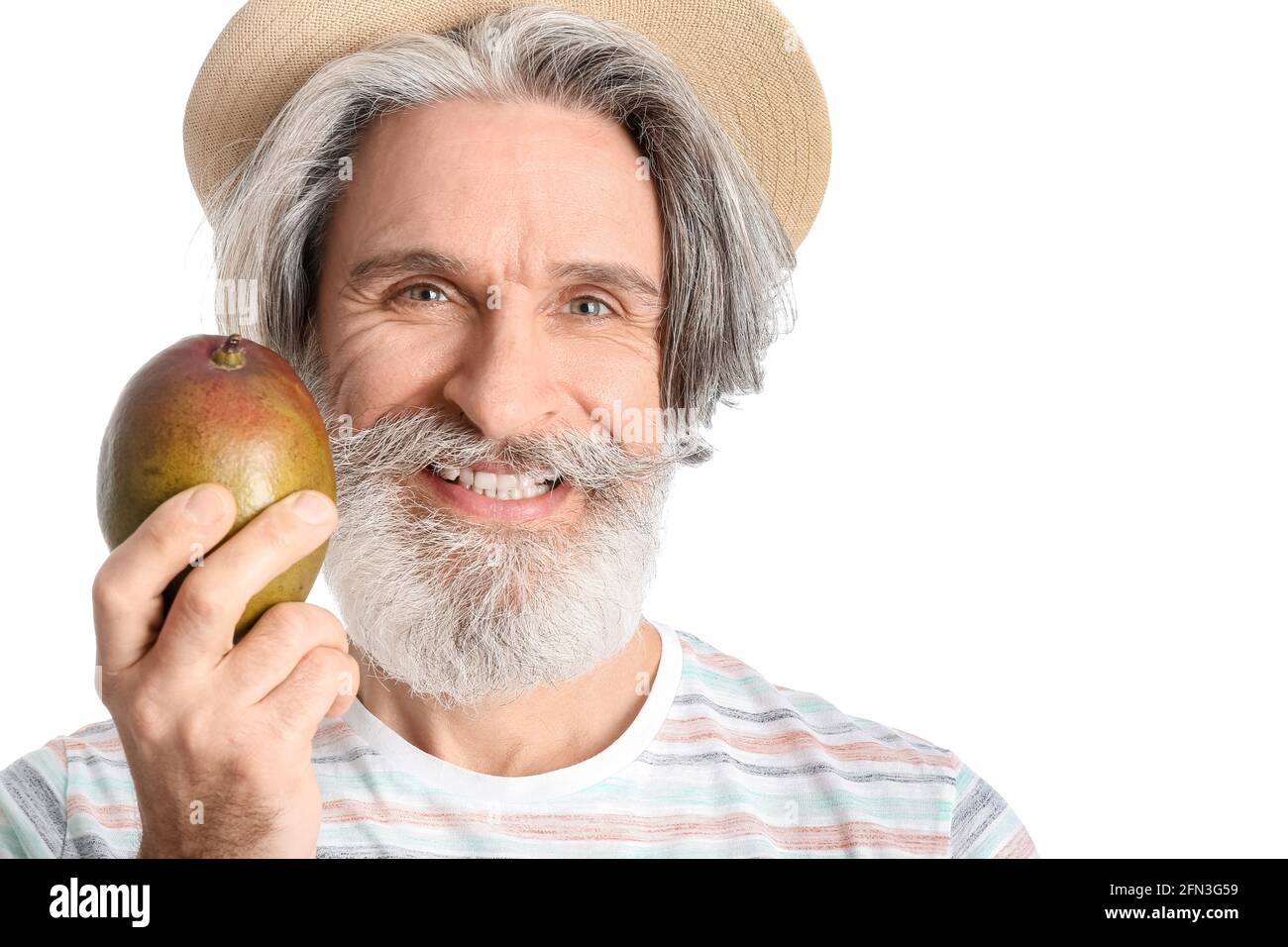 Senior man with fresh mango on white background Stock Photo - Alamy