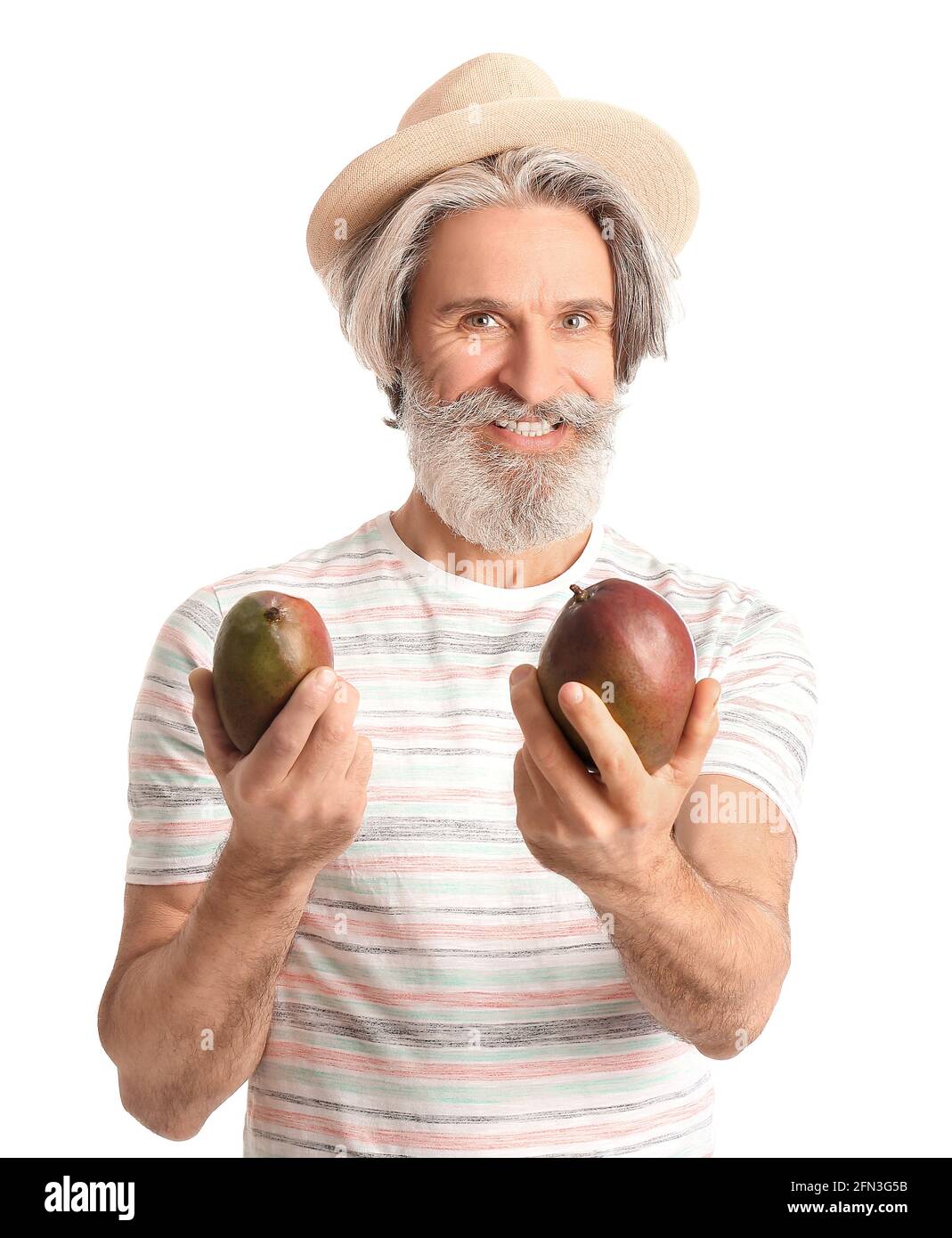 Senior man with fresh mango on white background Stock Photo - Alamy