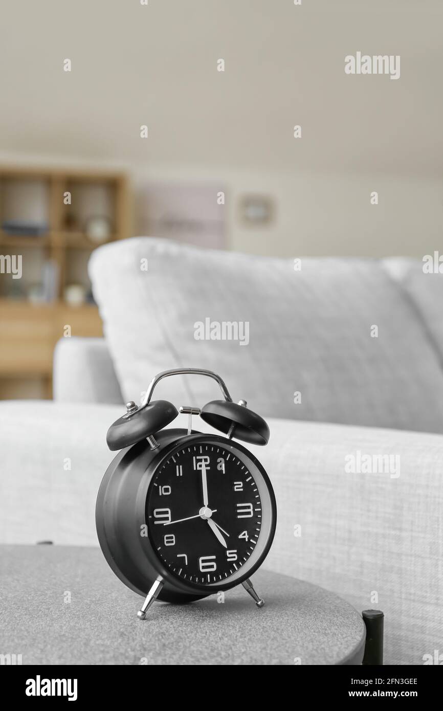 Alarm clock on table in room Stock Photo - Alamy
