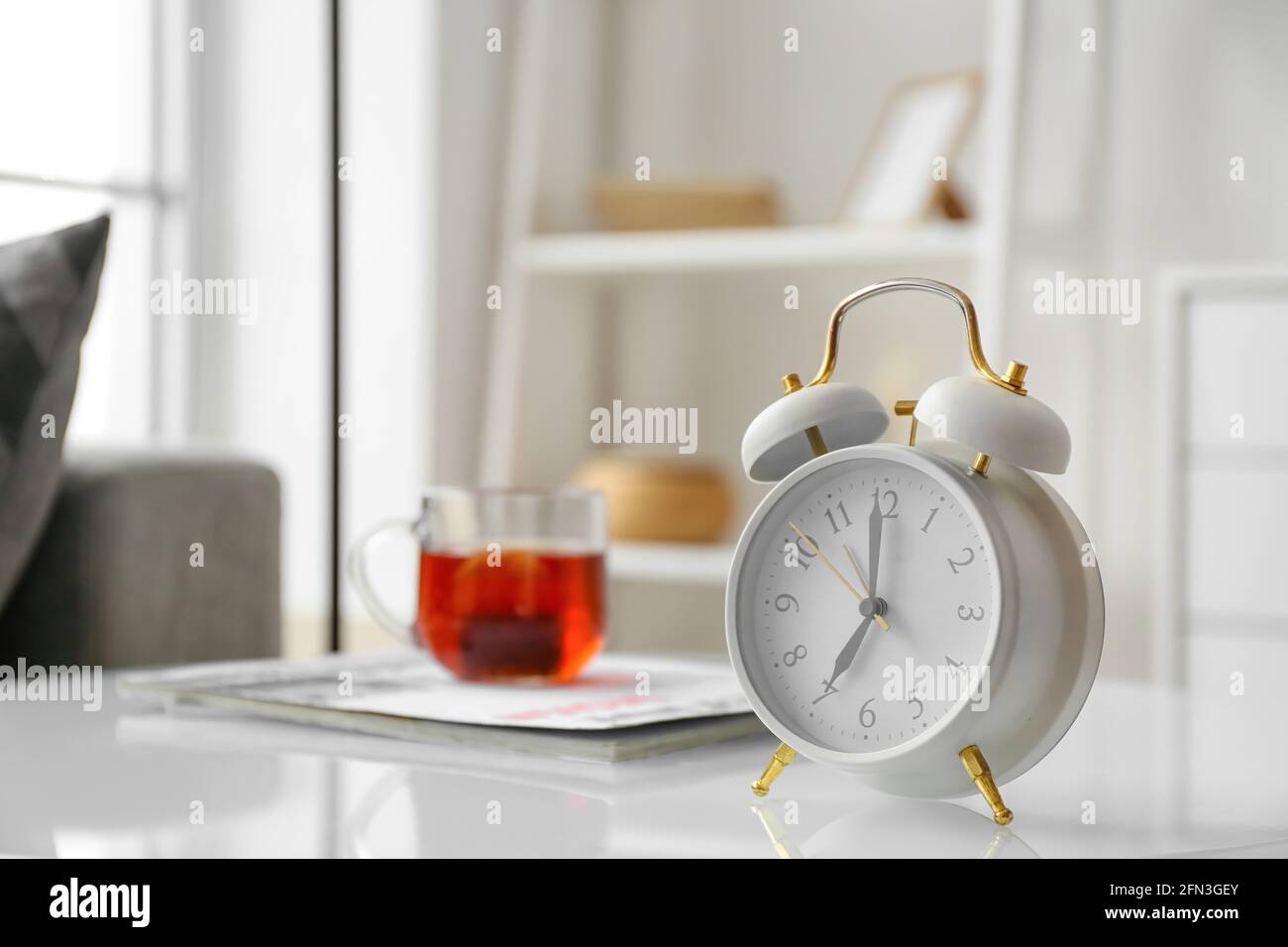 Alarm clock on table in room Stock Photo - Alamy