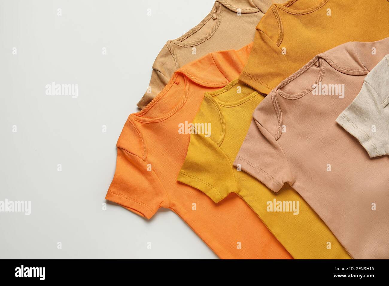 Baby clothes on white background Stock Photo - Alamy