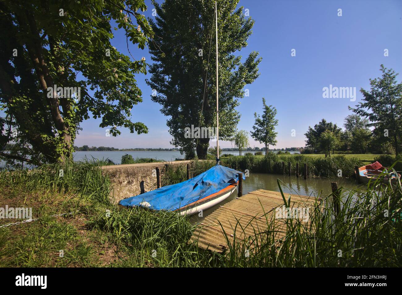 Mooring in an inlet of a river with docked boats Stock Photo - Alamy