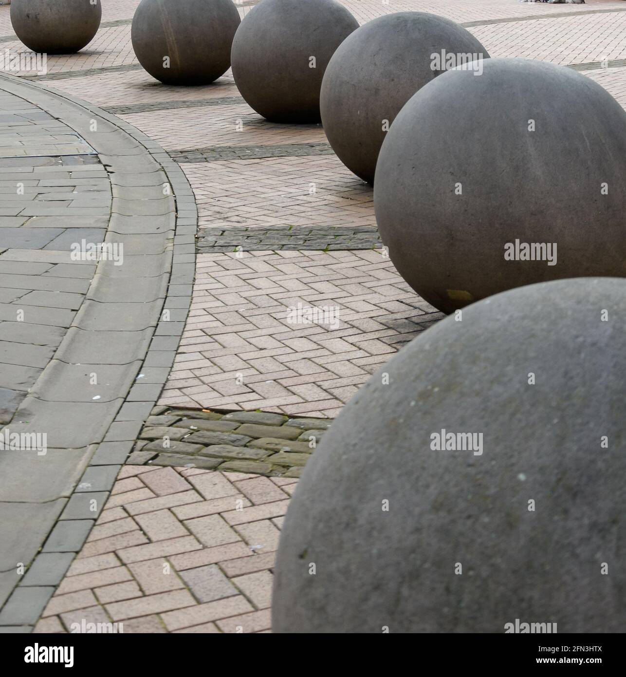 An arc of stone balls on a Birmingham pavement Stock Photo - Alamy