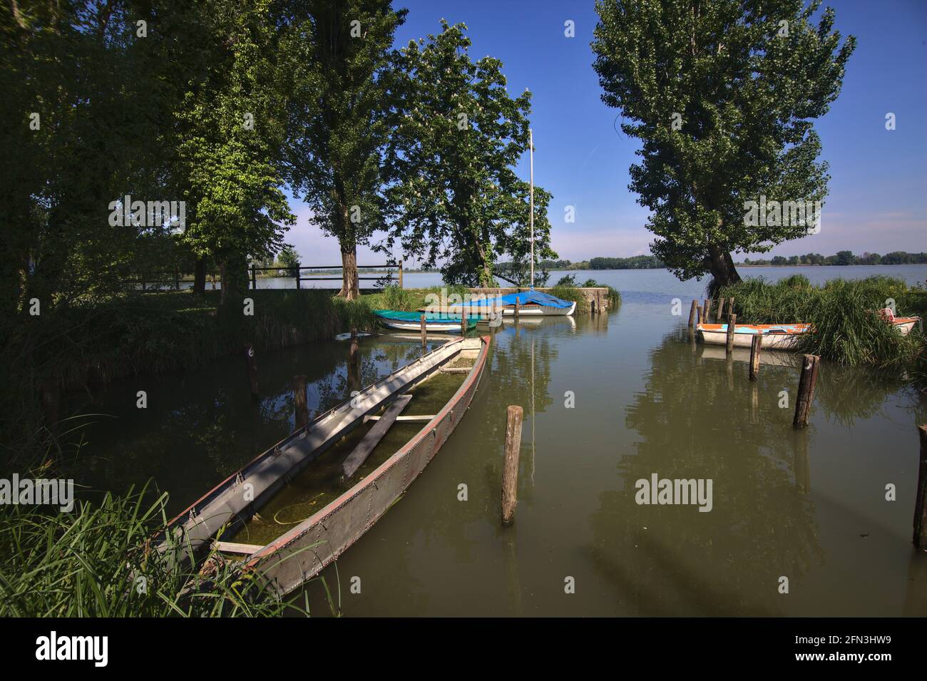 Mooring in an inlet of a river with docked boats Stock Photo - Alamy