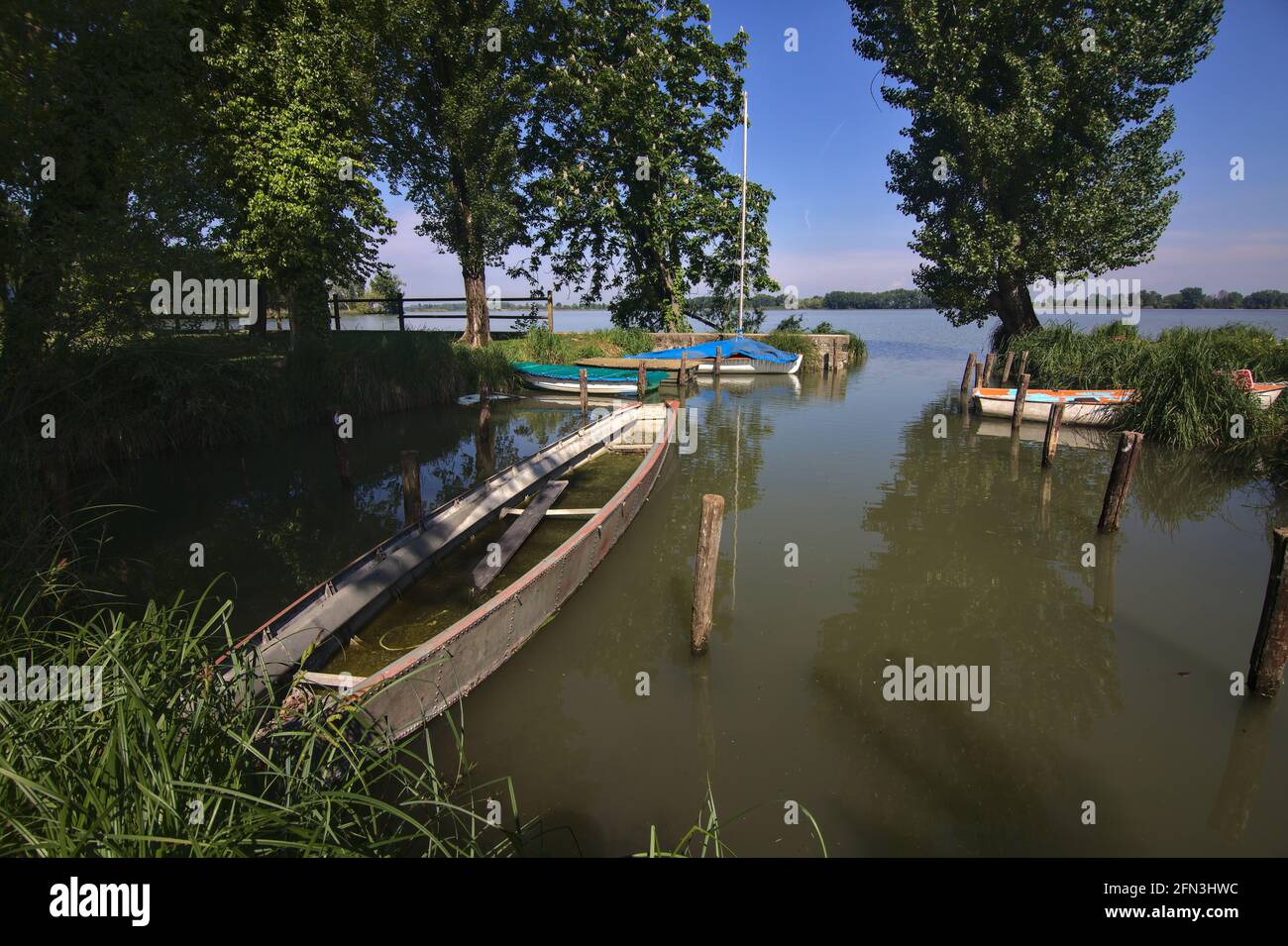 Mooring in an inlet of a river with docked boats Stock Photo - Alamy