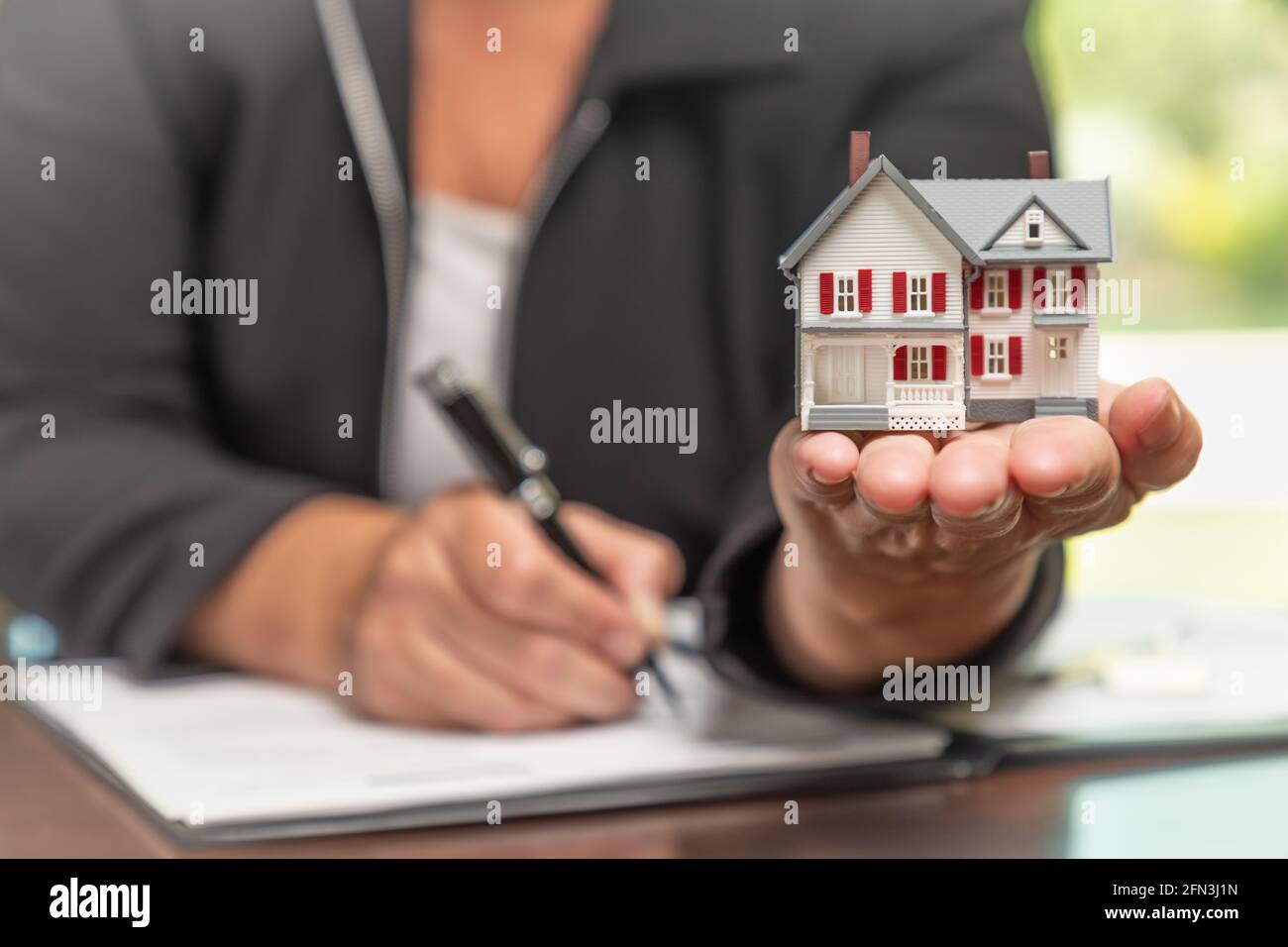 Female realtor holding sold sign hi-res stock photography and images ...