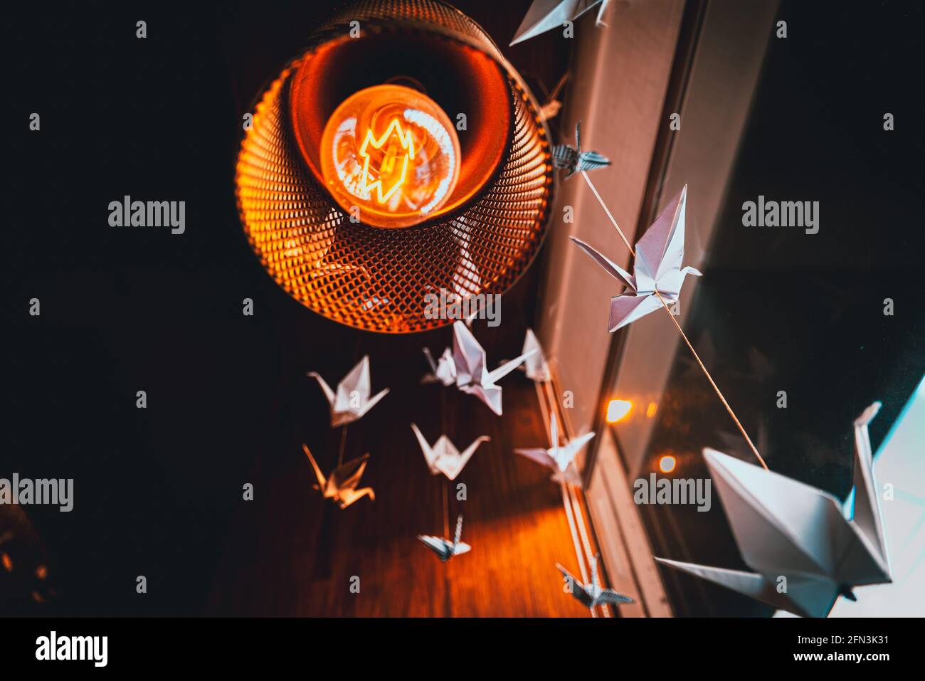 Perspective view from underneath of several origami swans hanging from ...