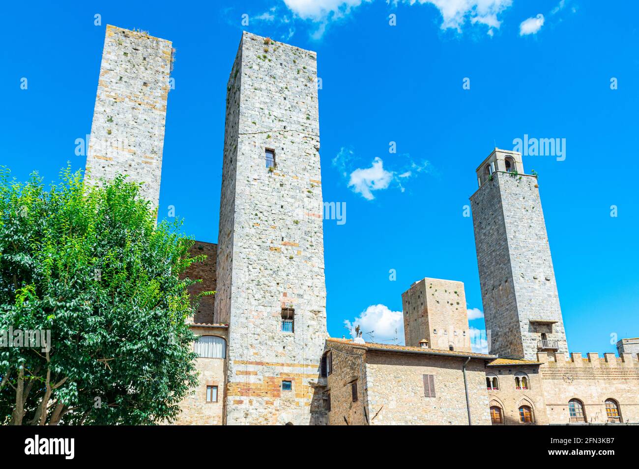 Low angle shot of tall medieval towers in the ancient Tuscan town of ...